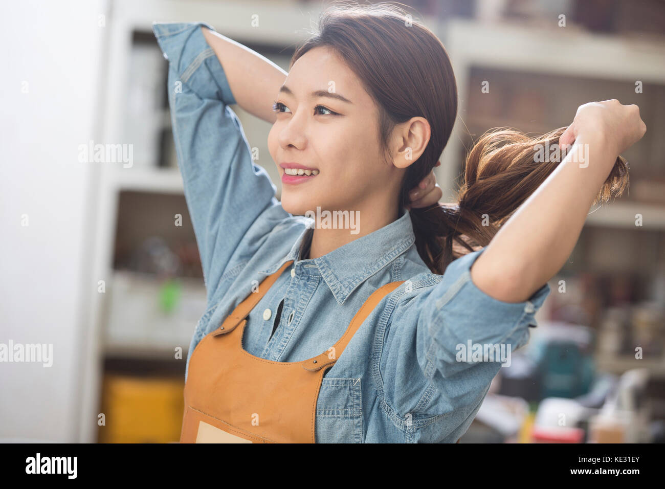 Portrait of young smiling female woodworker Stock Photo - Alamy