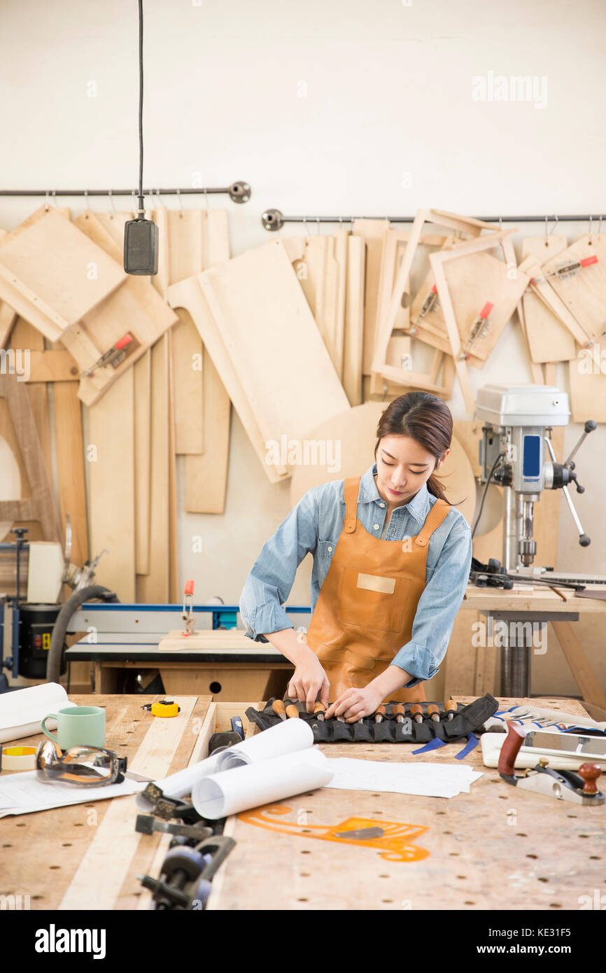 Young female woodworker concentrating on her work Stock Photo - Alamy