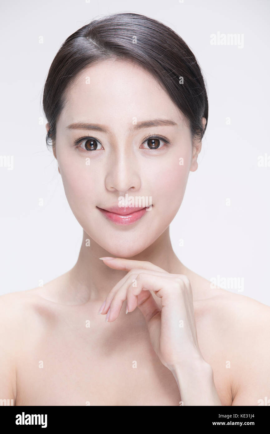 Portrait smiling beautiful young woman touching her face hi-res stock ...