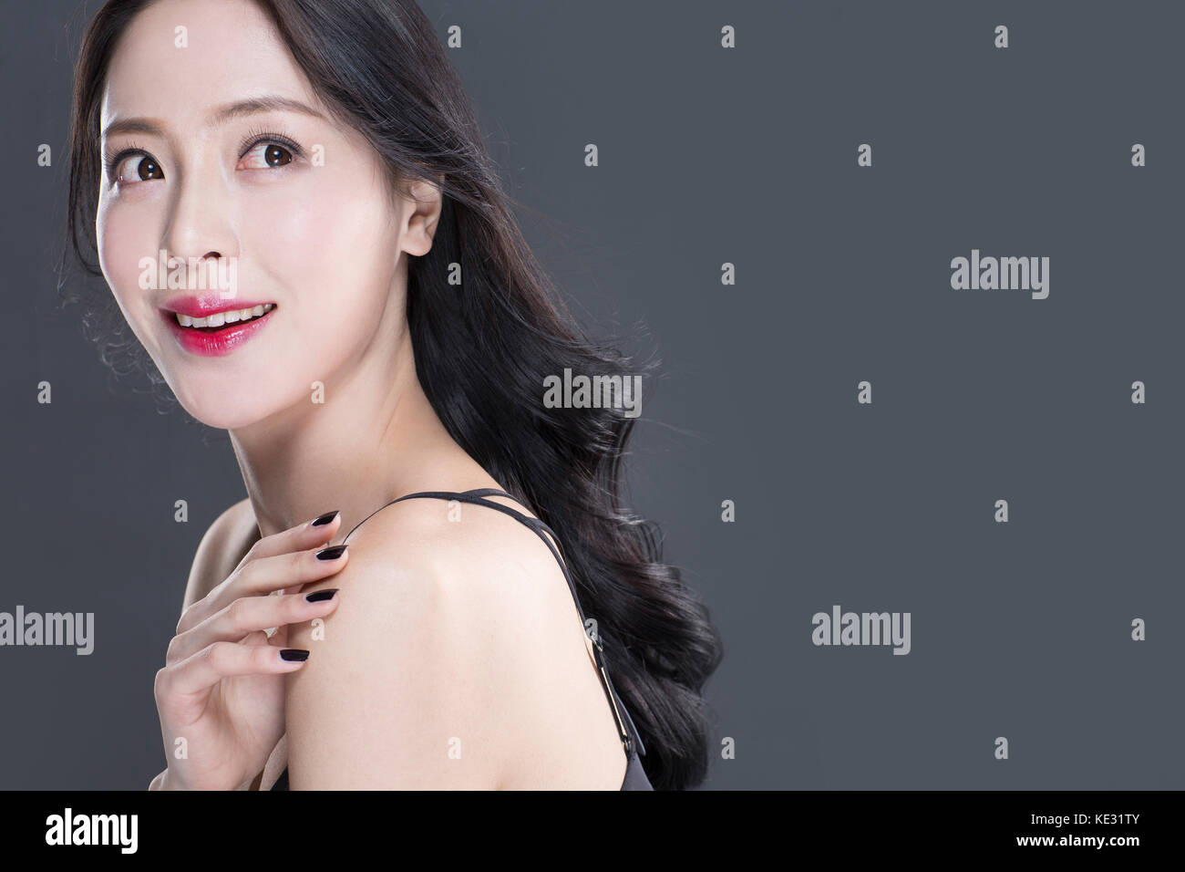 Side view portrait of young smiling woman with long wavy hair Stock ...