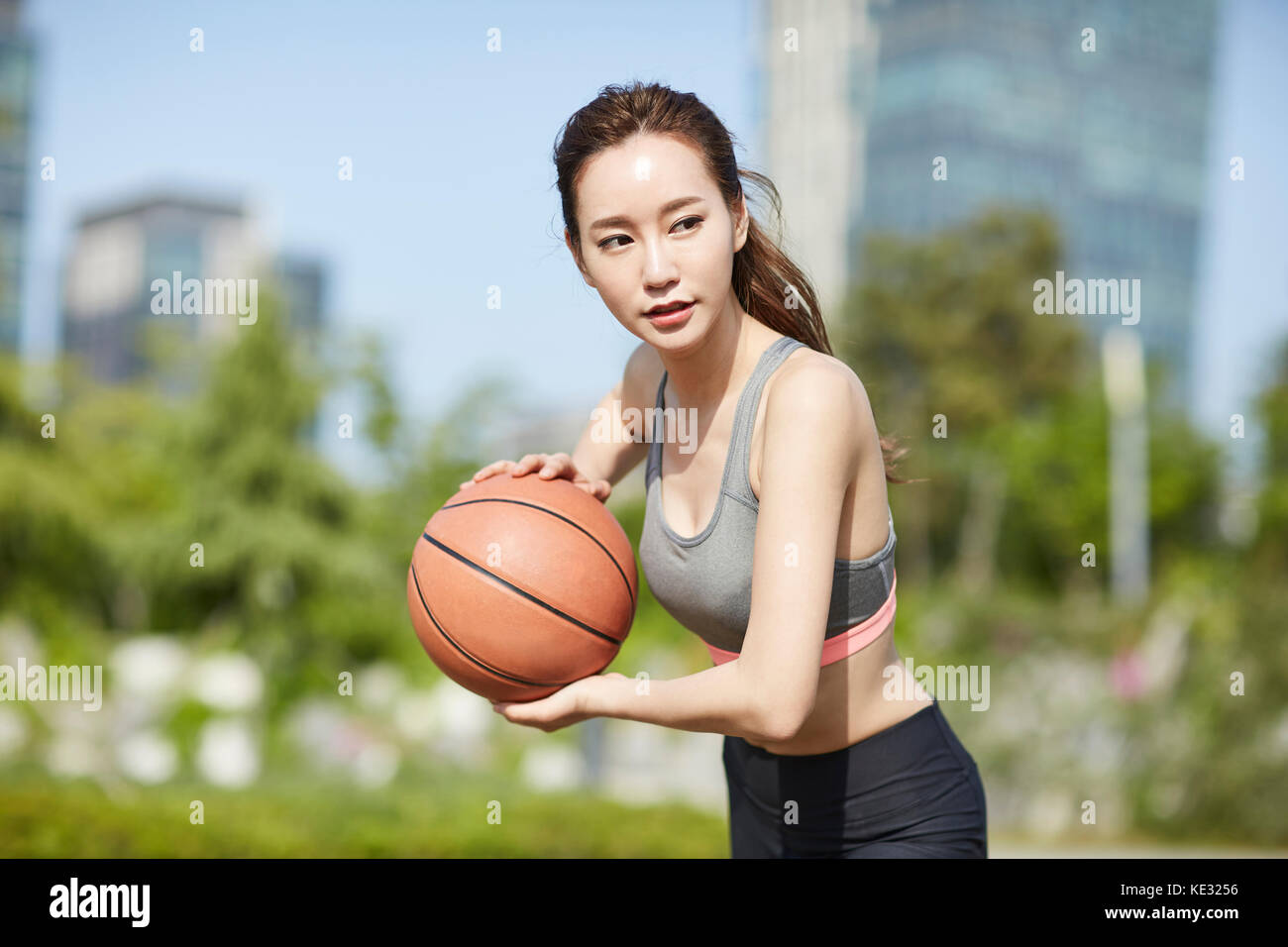 Young slim woman in sportswear posing with a basketball Stock Photo - Alamy