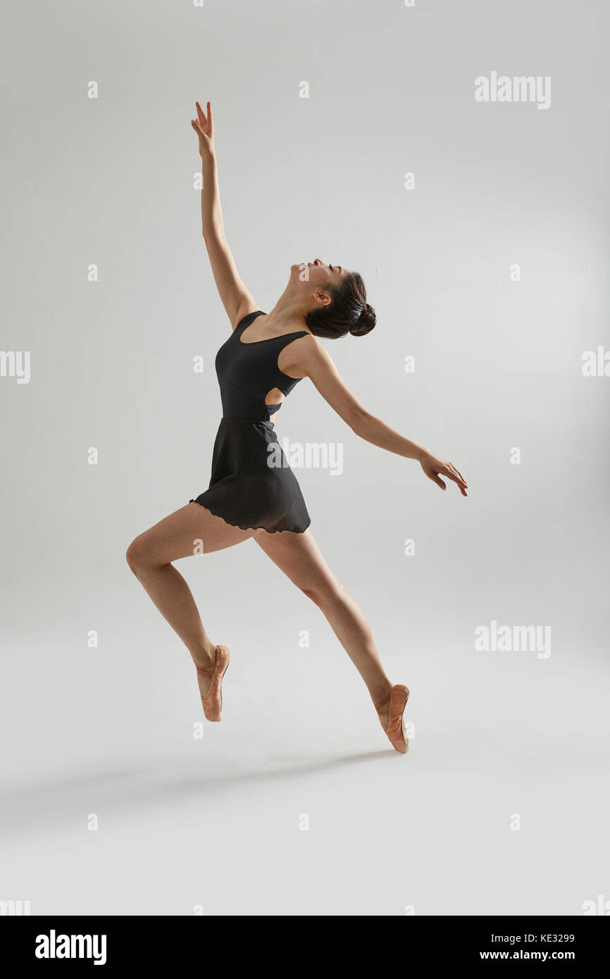 Side view of young ballerina in black leotard posing elegantly Stock ...