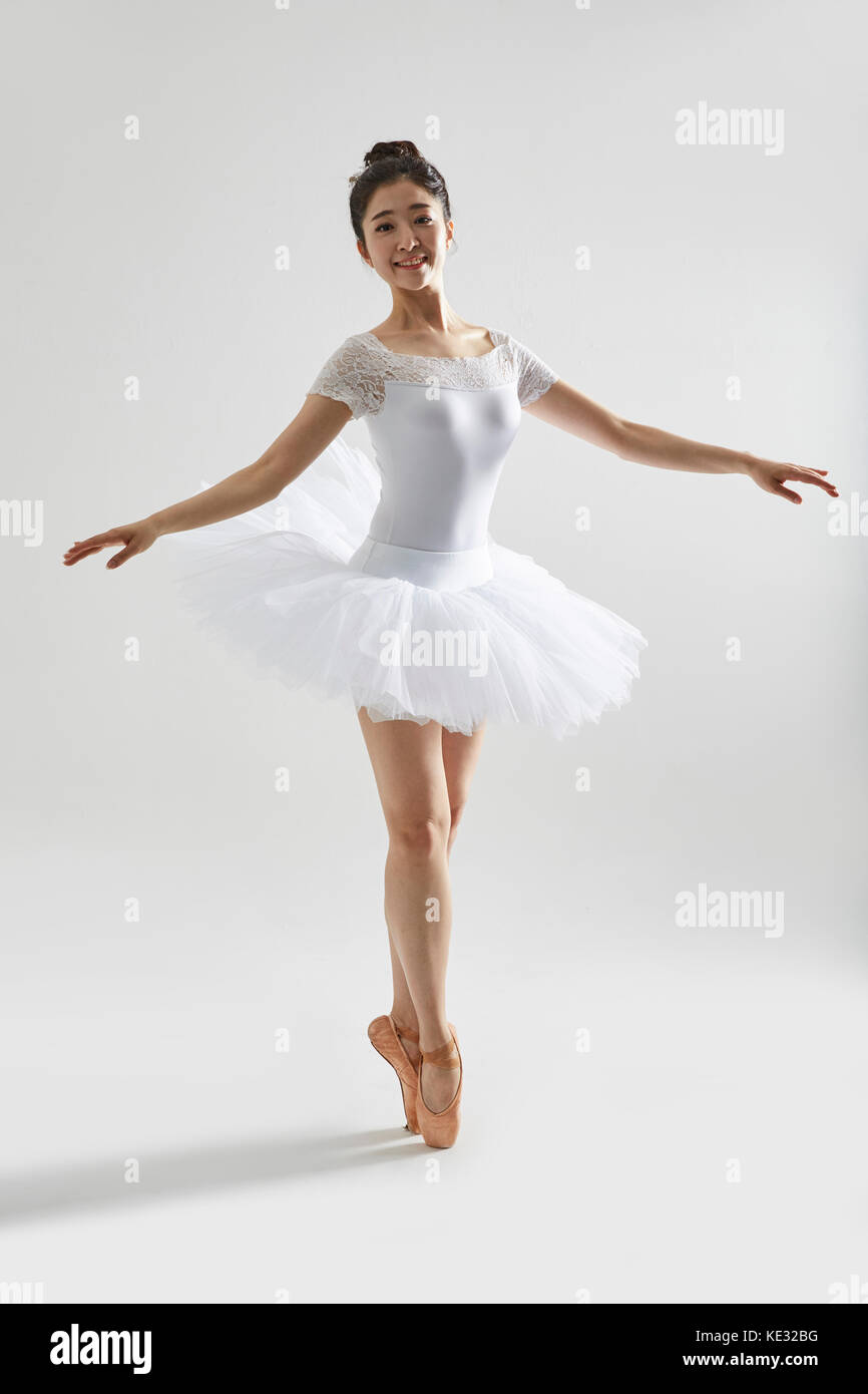 Young smiling woman in white ballet clothes posing elegantly Stock ...