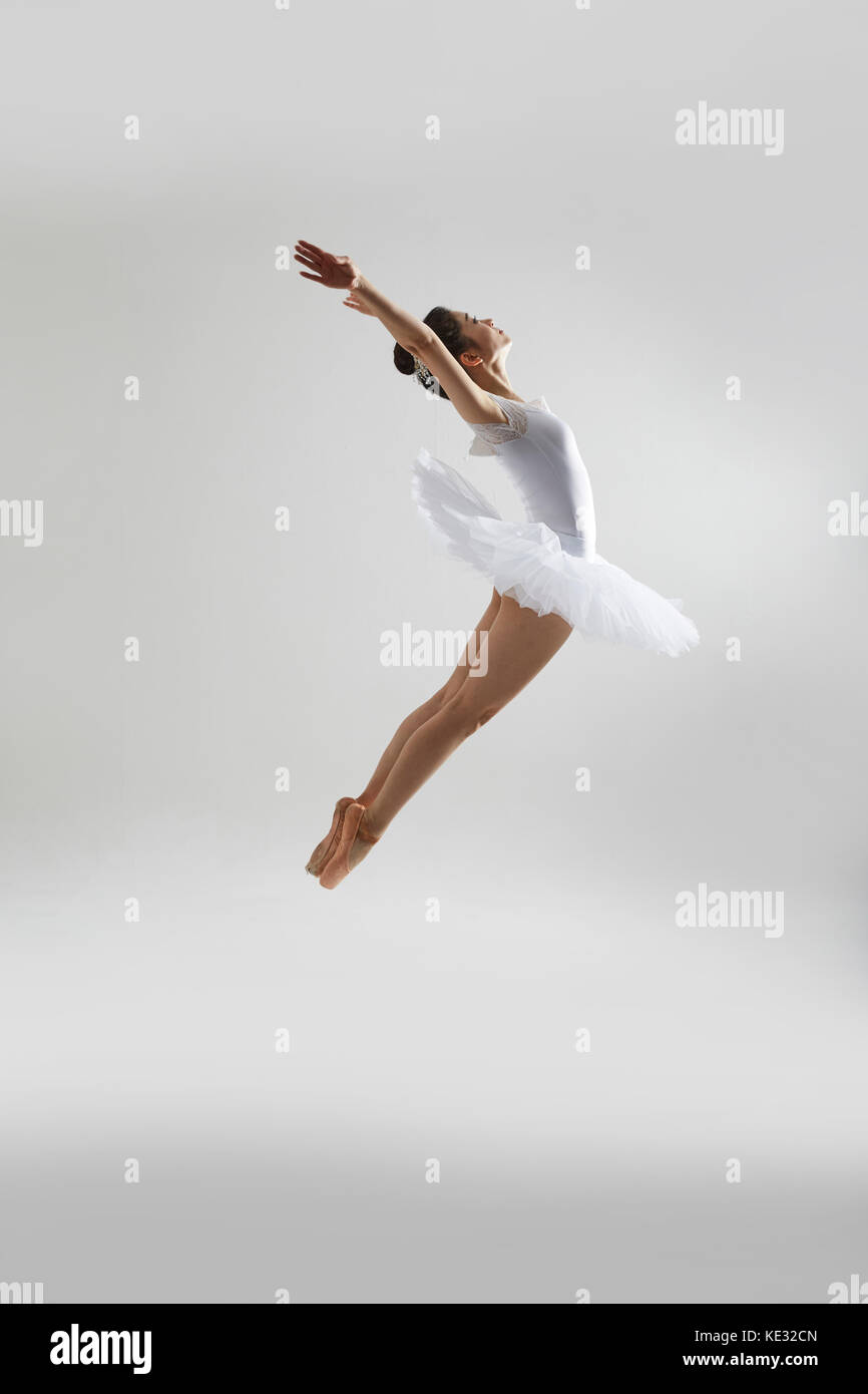 Side view of young elegant ballerina jumping Stock Photo - Alamy