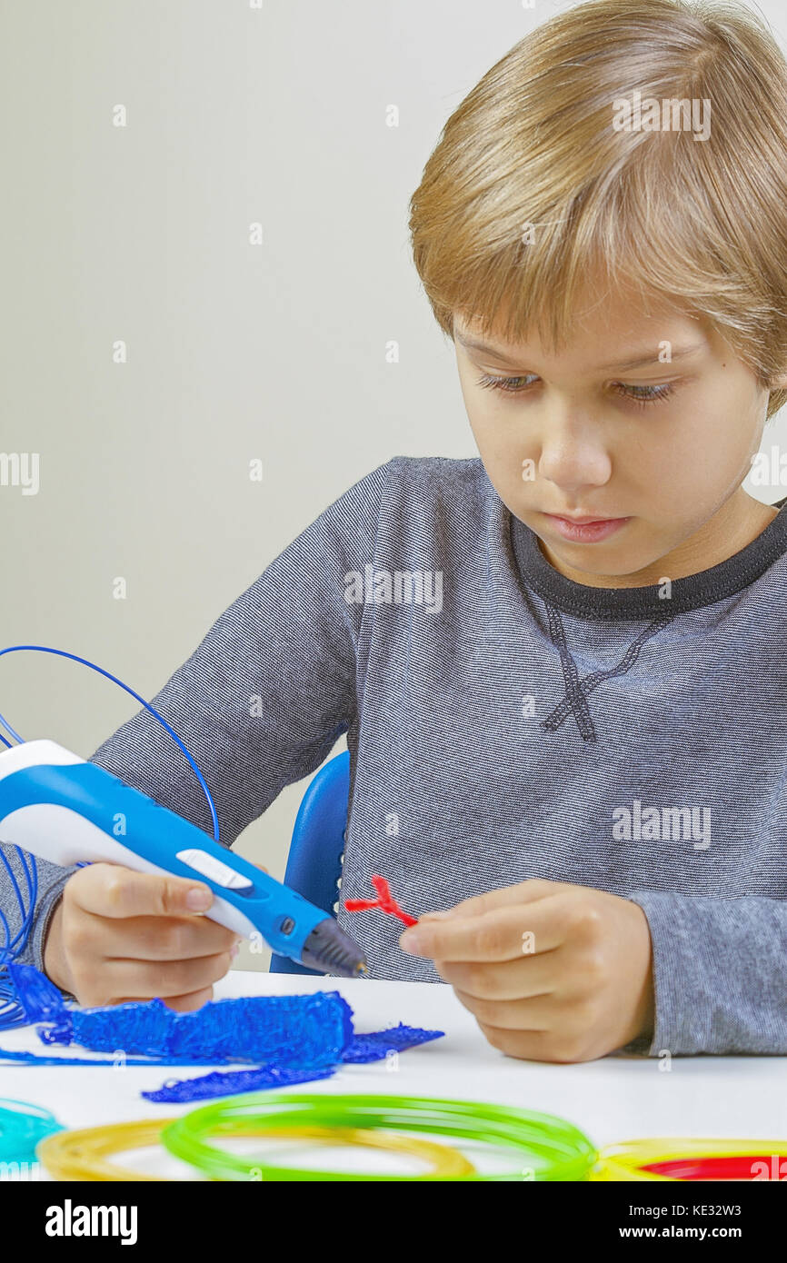Focused child creating with 3d printing pen Stock Photo - Alamy
