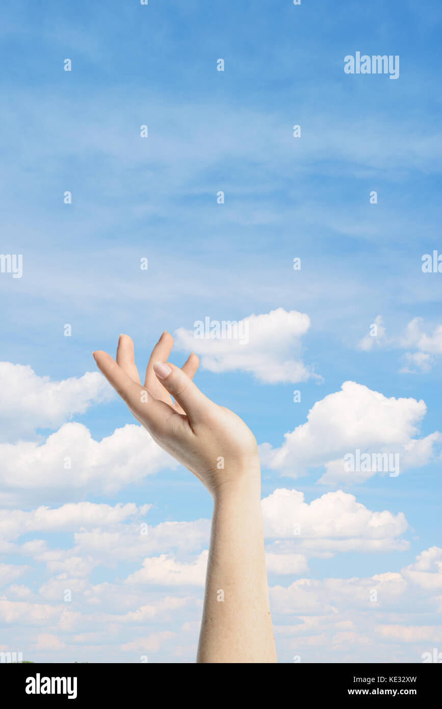 Elegant womans hand reaching blue peaceful sky Stock Photo - Alamy