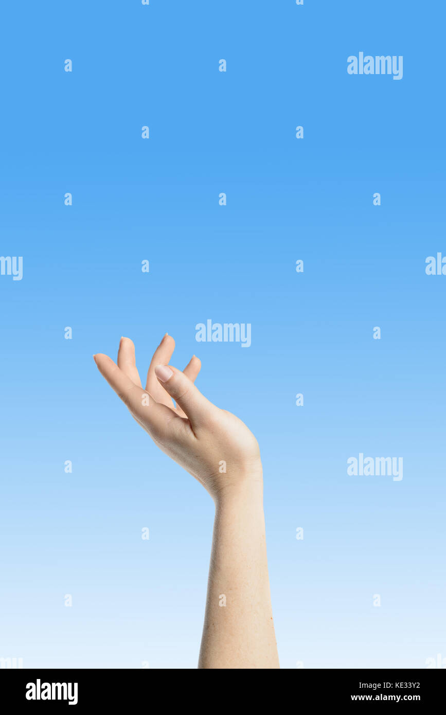 Elegant womans hand reaching blue peaceful sky Stock Photo - Alamy
