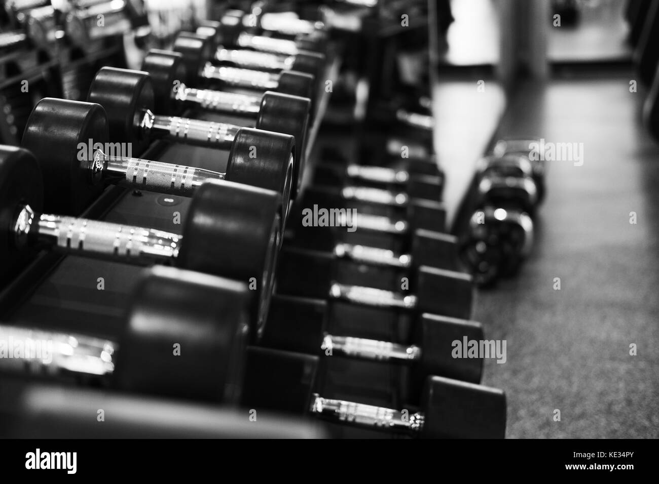 Row of dumbbells in gym. Black dumbbell set in sport fitness club ...