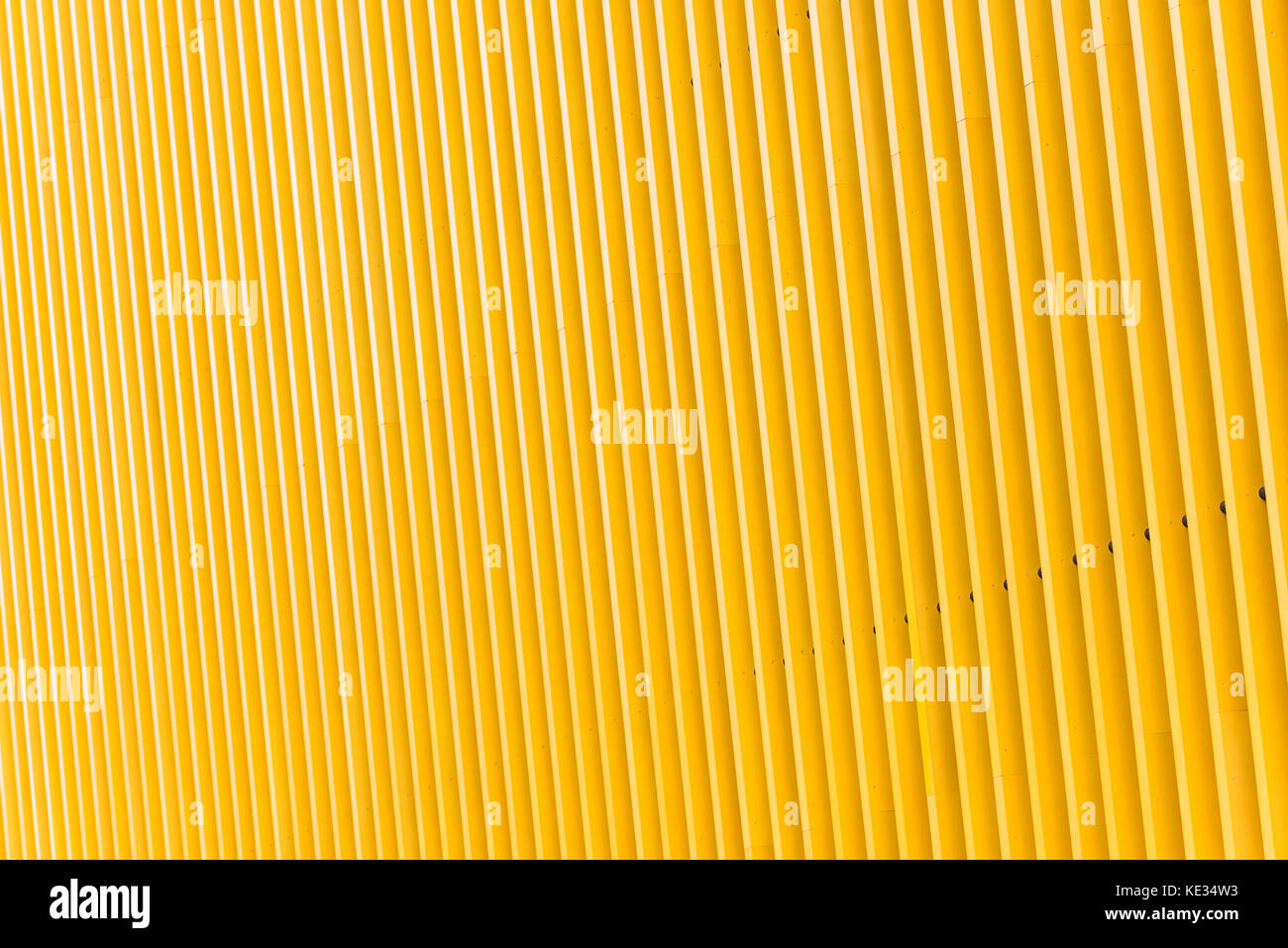 Detail of bright yellow metal building facade. For background Stock ...
