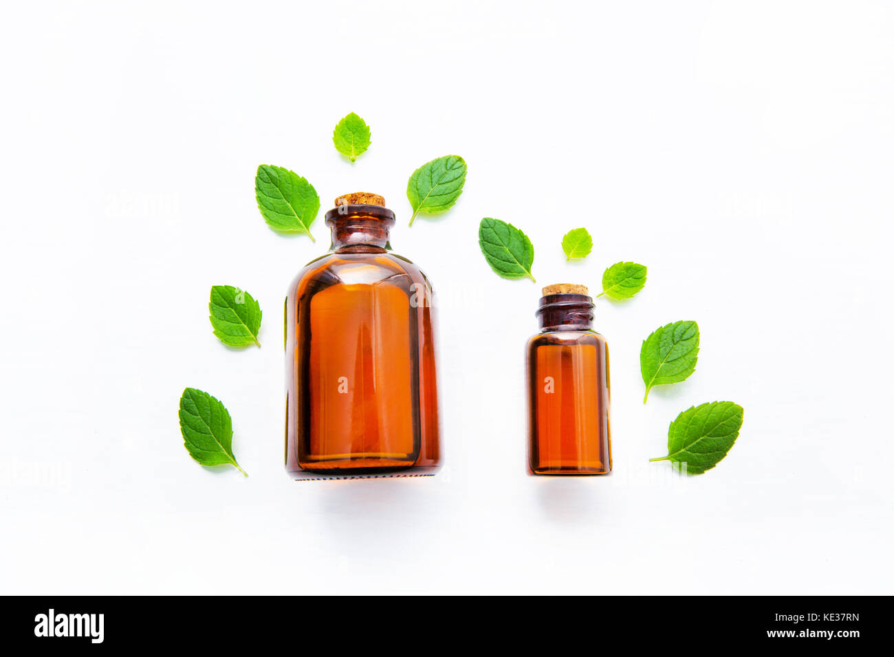 Natural Mint Essential Oil in a Glass Bottle with Fresh Mint Leaves on ...