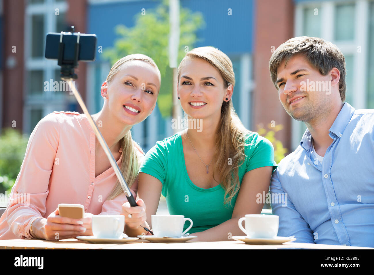 Female using selfie stick hi-res stock photography and images - Alamy
