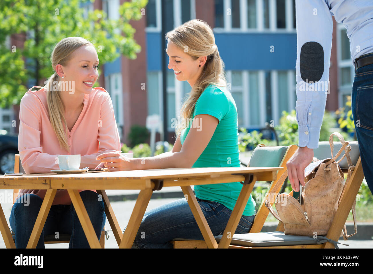 Thief Trying To Steal Bag While Female Friends Talking At Cafe Stock ...