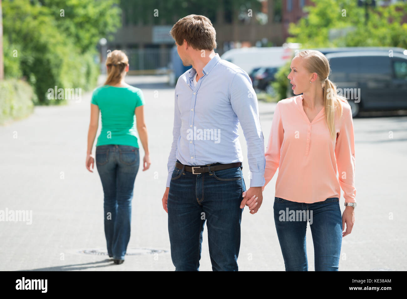 Young Woman Shouting At Her Boyfriend Looking At Another Woman On ...