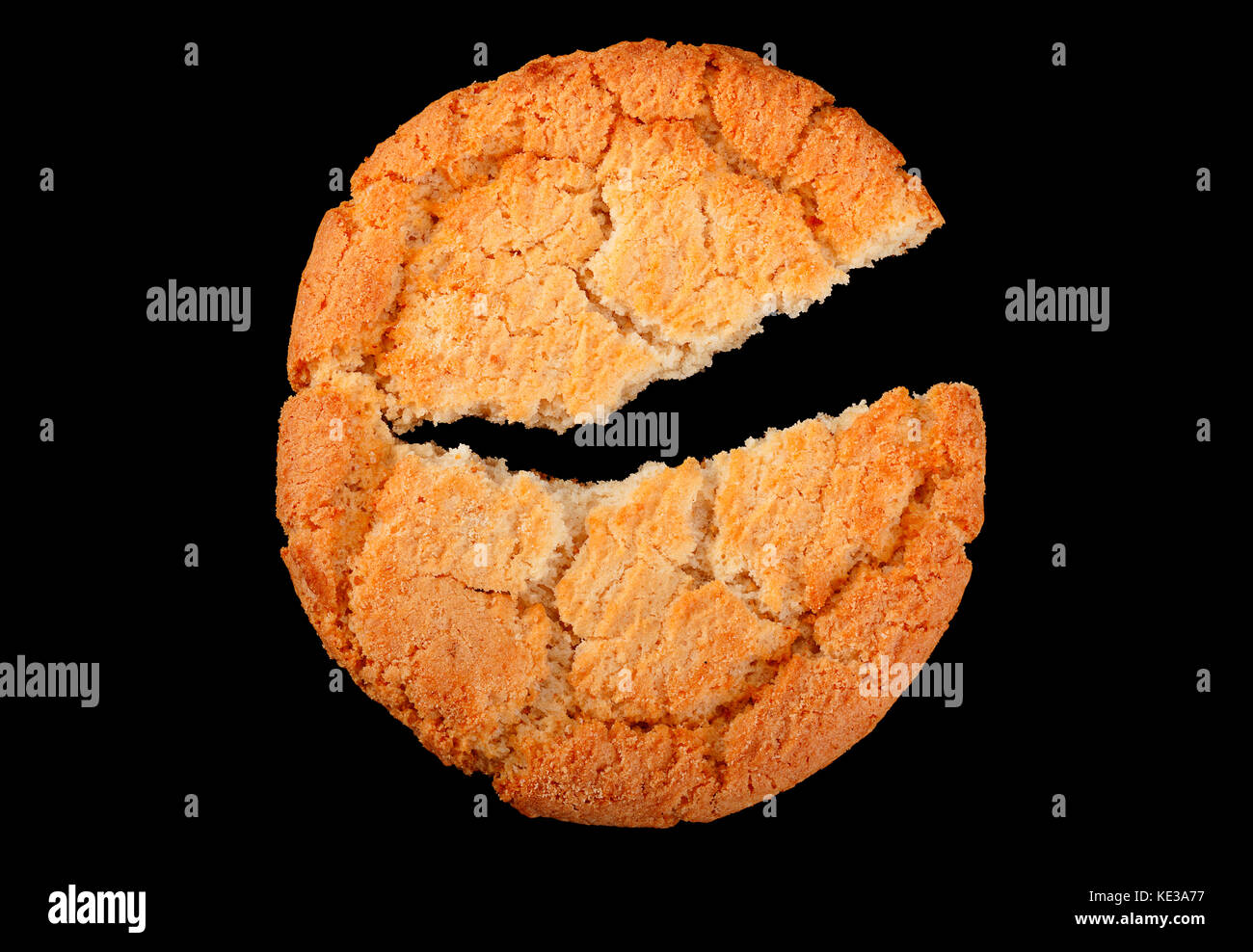 Cracked biscuit closeup isolated on black background Stock Photo - Alamy