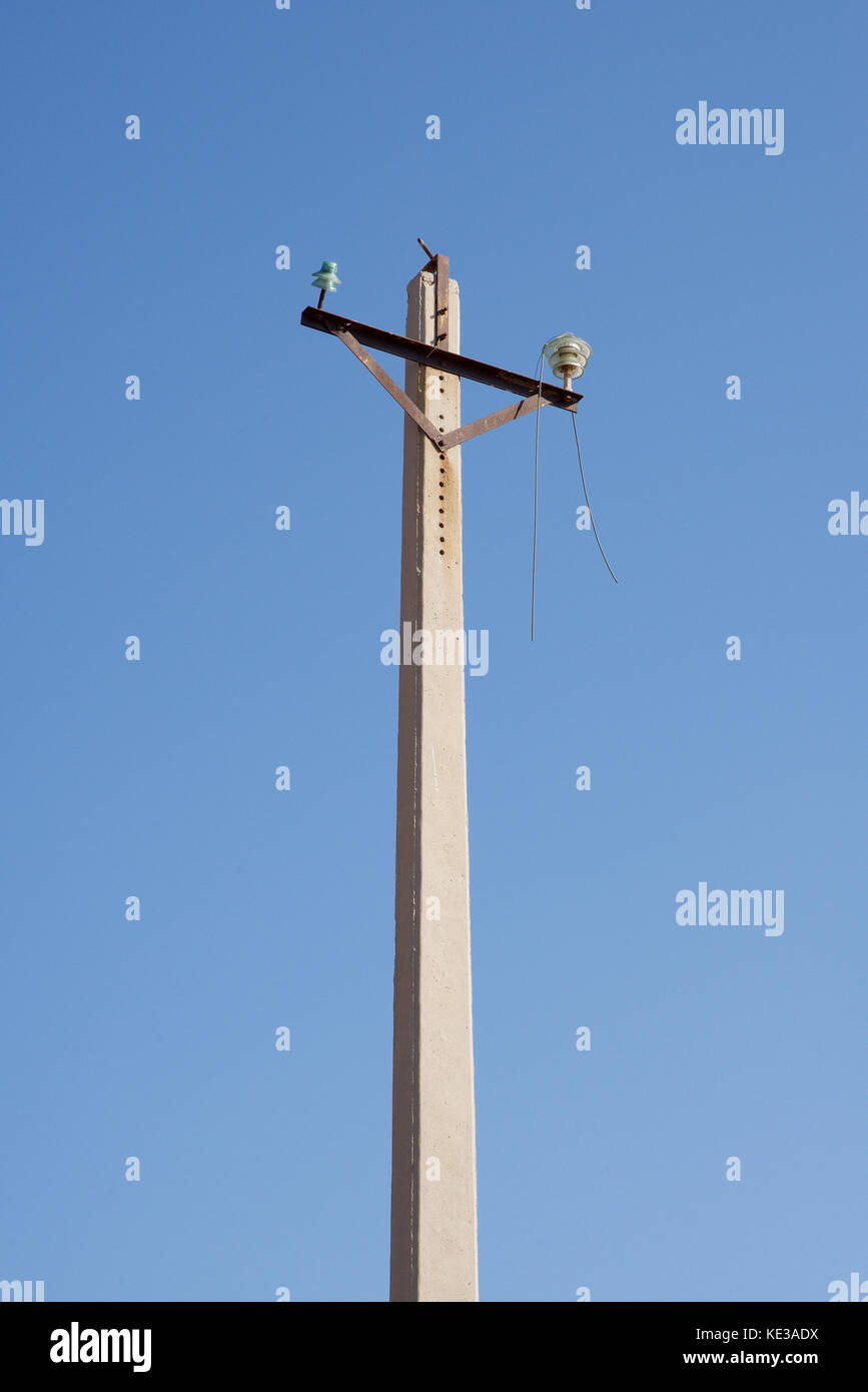 Concrete post of an old power supply - with broken cable Stock Photo ...