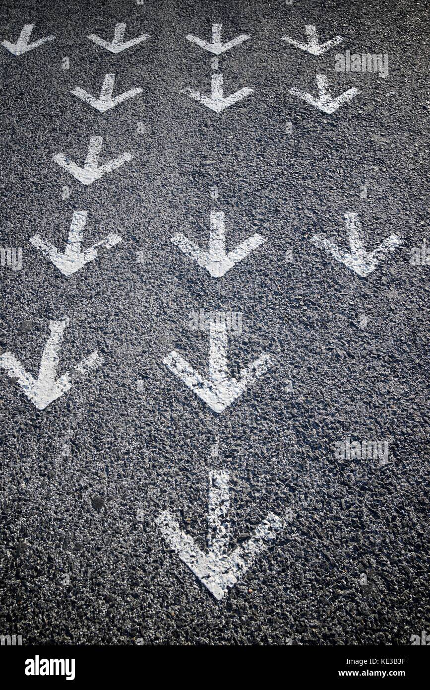Directional arrows painted on a cement floor Stock Photo - Alamy