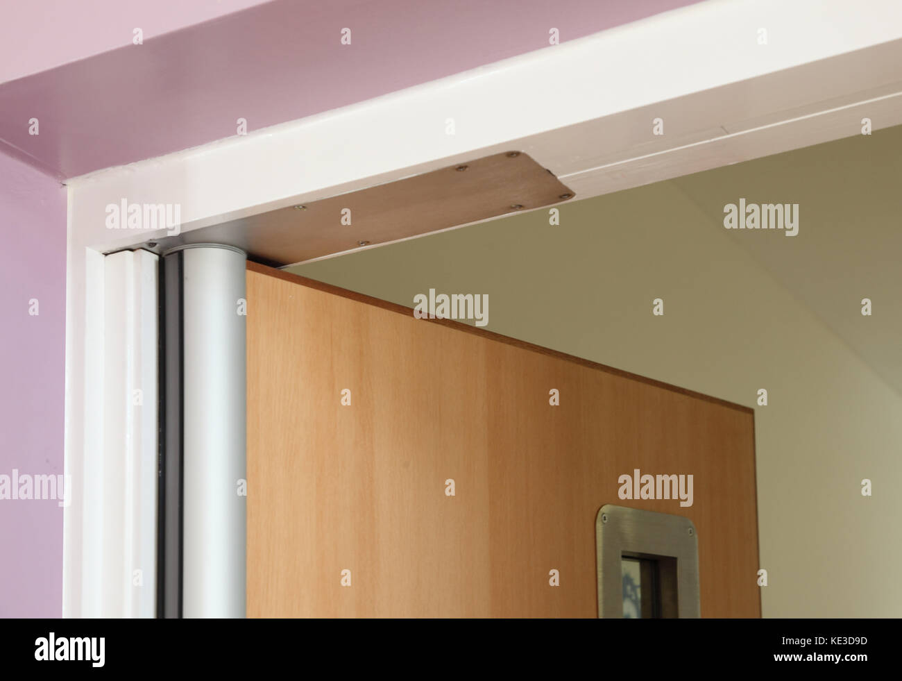 Close-up of an internal fire door showing a concealed closer mechanism ...