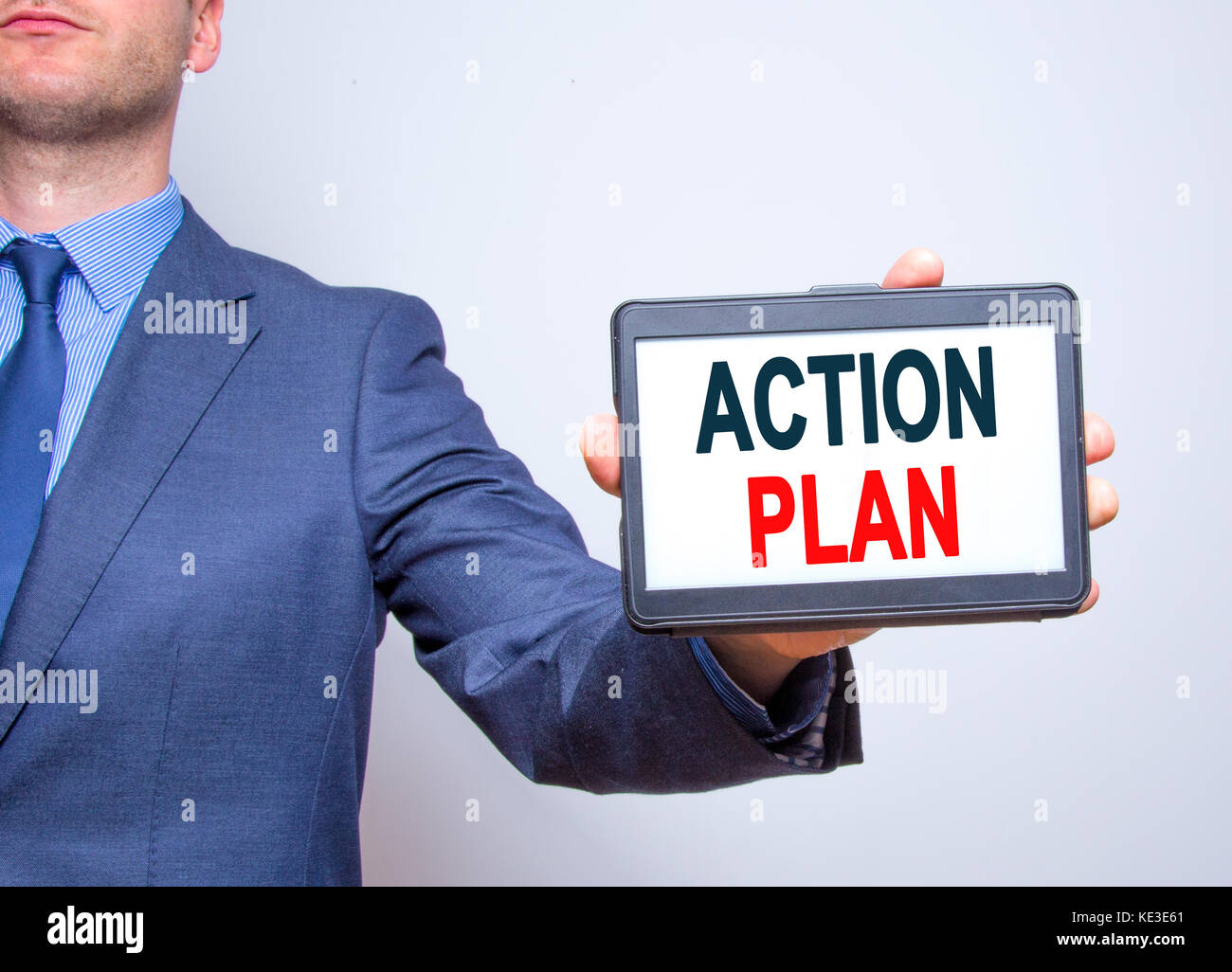 Businessman hand holding tablet with Action Plan text sign. Isolated on ...