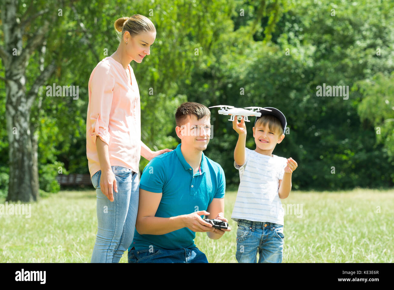 A Boy Operating The Drone By Remote Control With His Parents In The ...