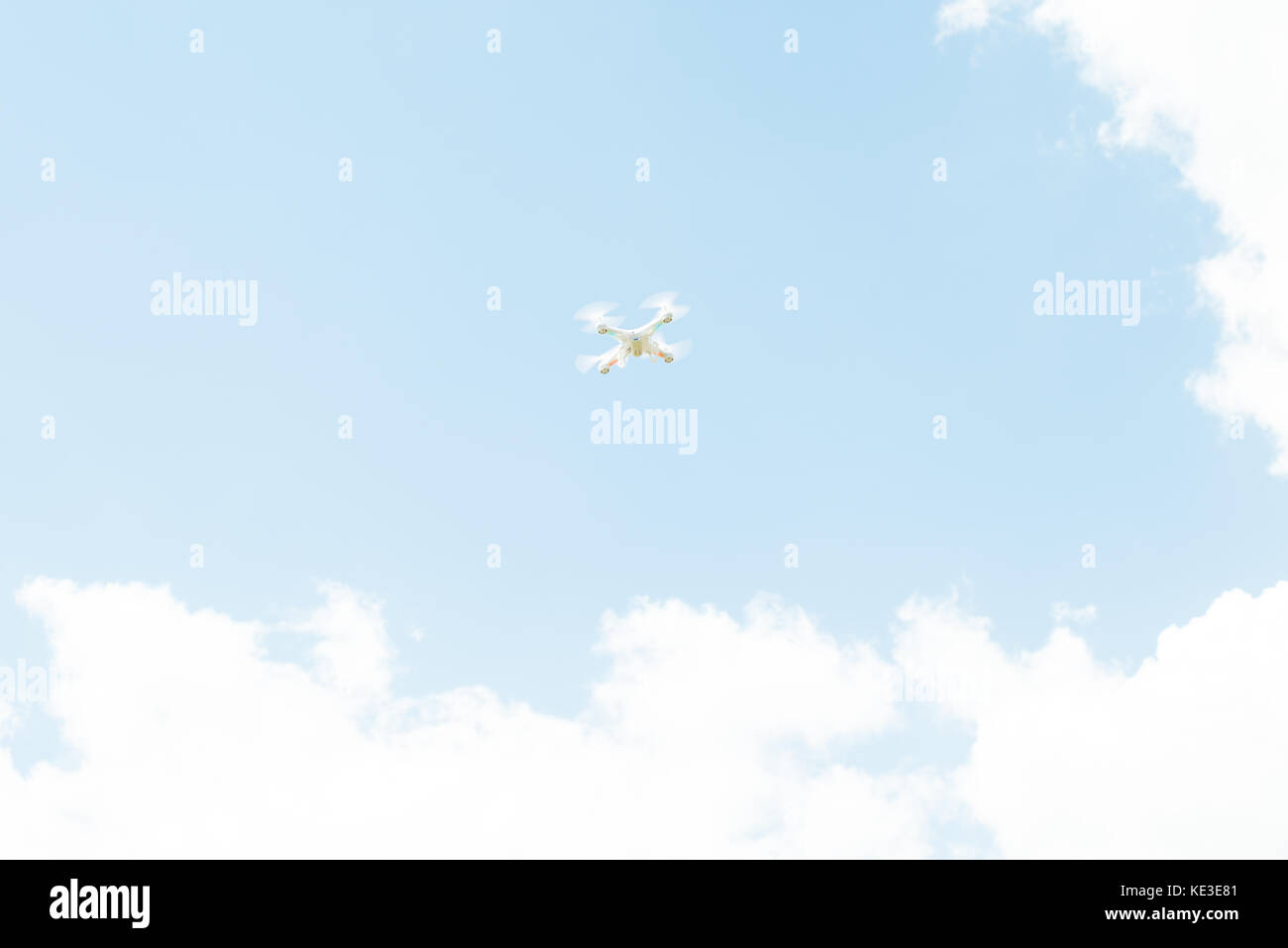 White Drone Quad Copter Flying In The Sky Stock Photo - Alamy