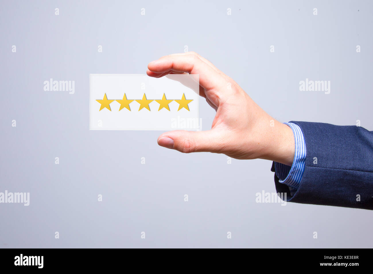 Businessman hand holding five stars isolated on background. Business ...