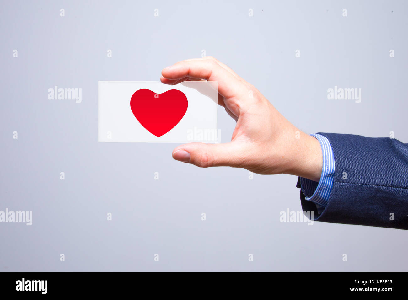 Businessman holding a red heart in his hand - crm - service mind Stock ...