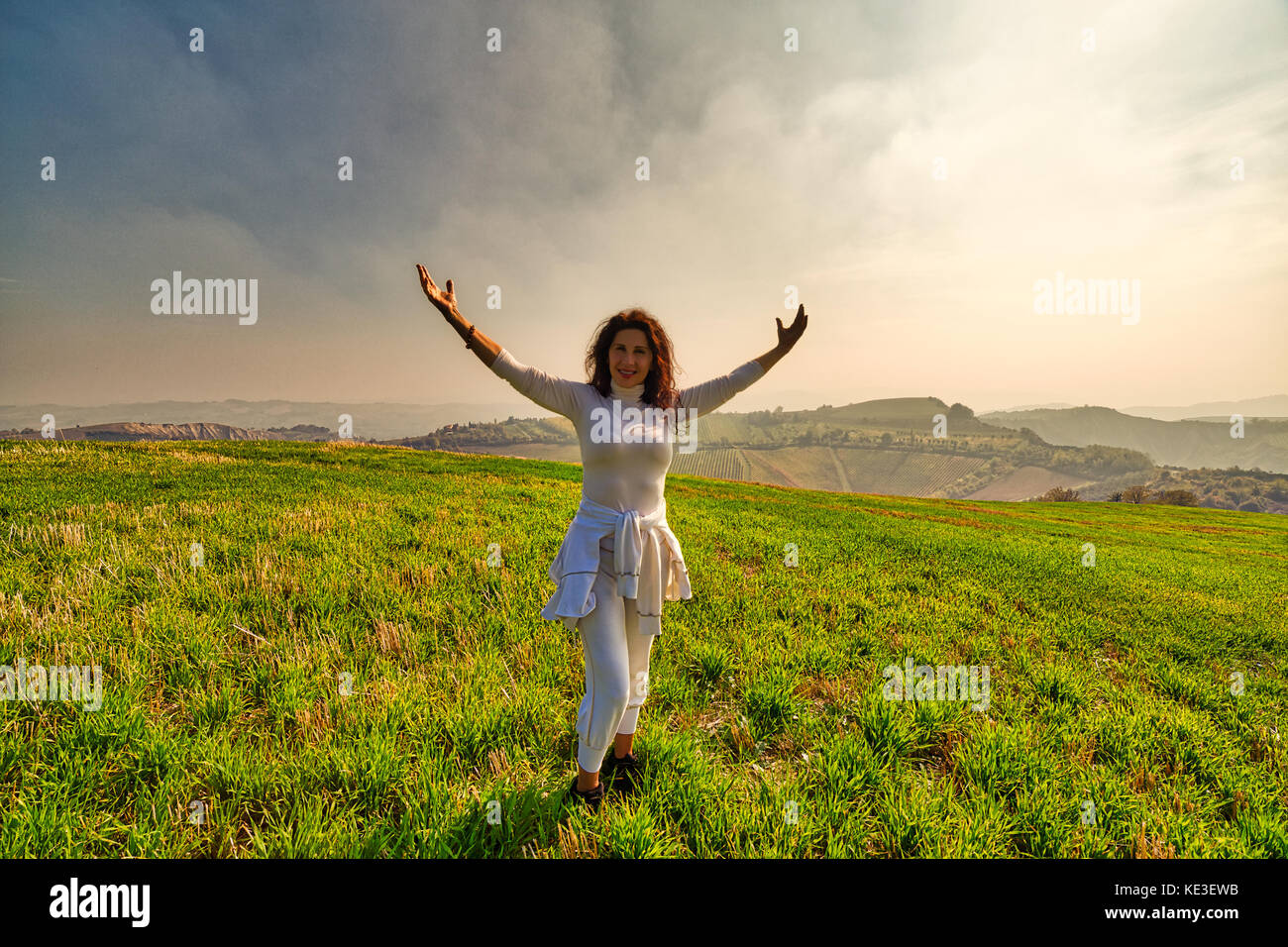 Woman raising arms hi-res stock photography and images - Alamy