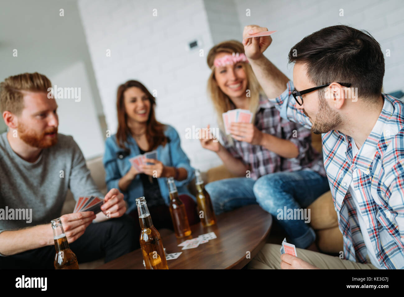 Group of friends having fun while playing cards Stock Photo - Alamy