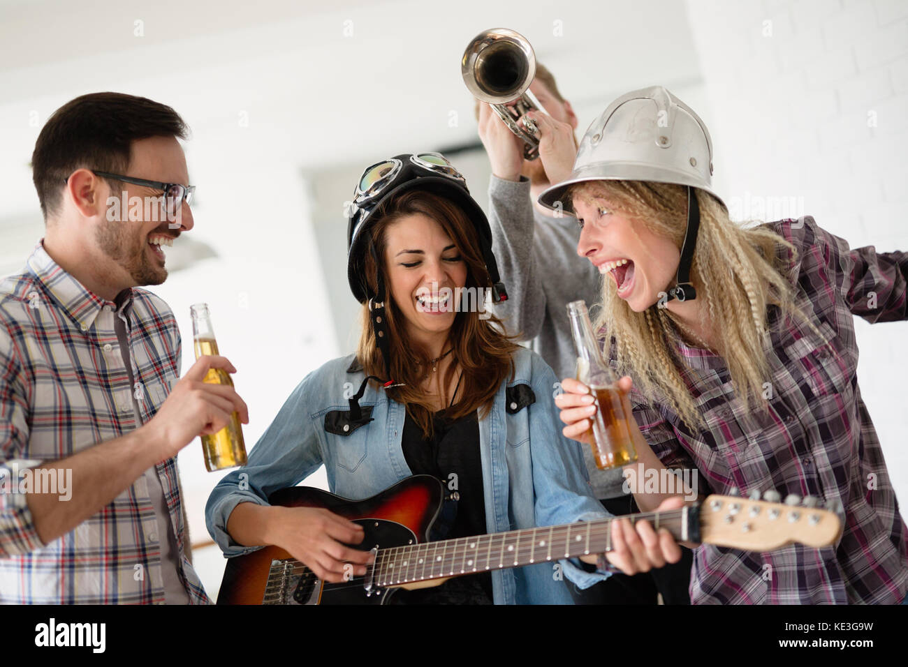 Happy group of friends playing instruments and partying Stock Photo - Alamy