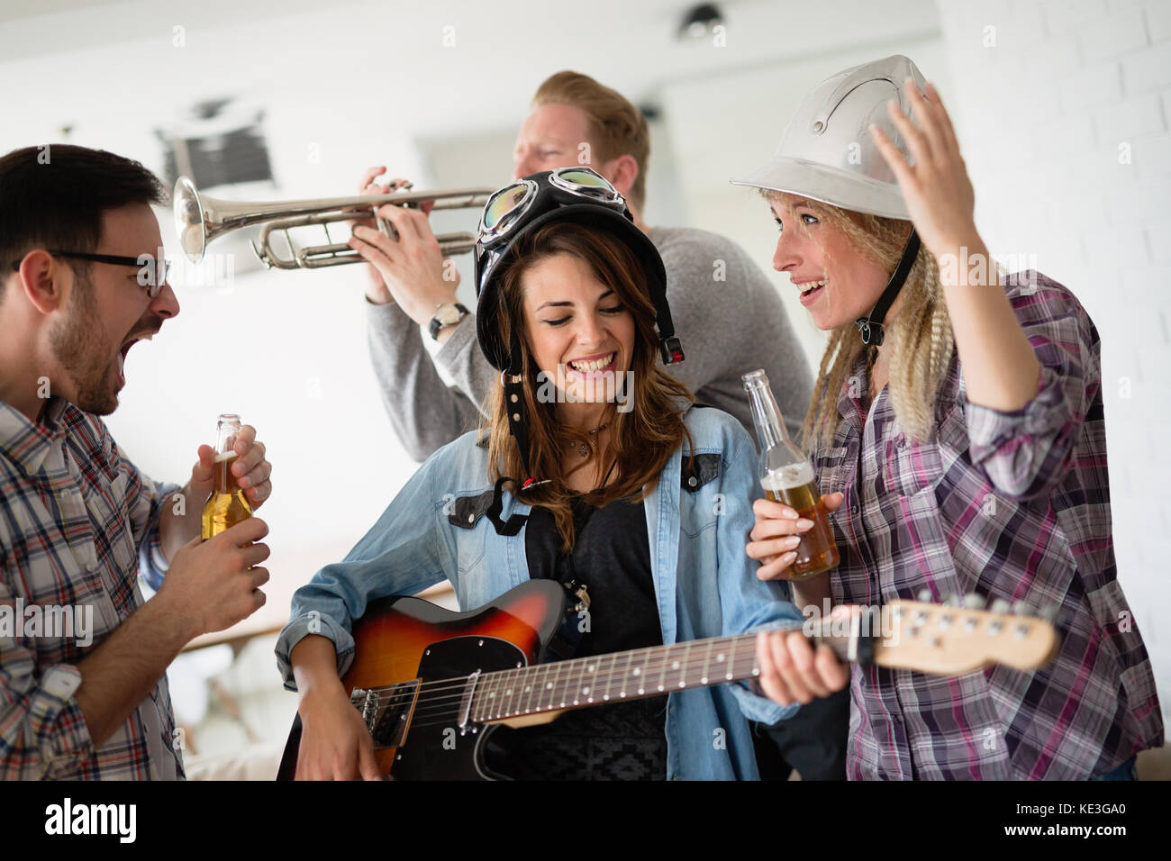 Happy group of friends playing instruments and partying Stock Photo - Alamy
