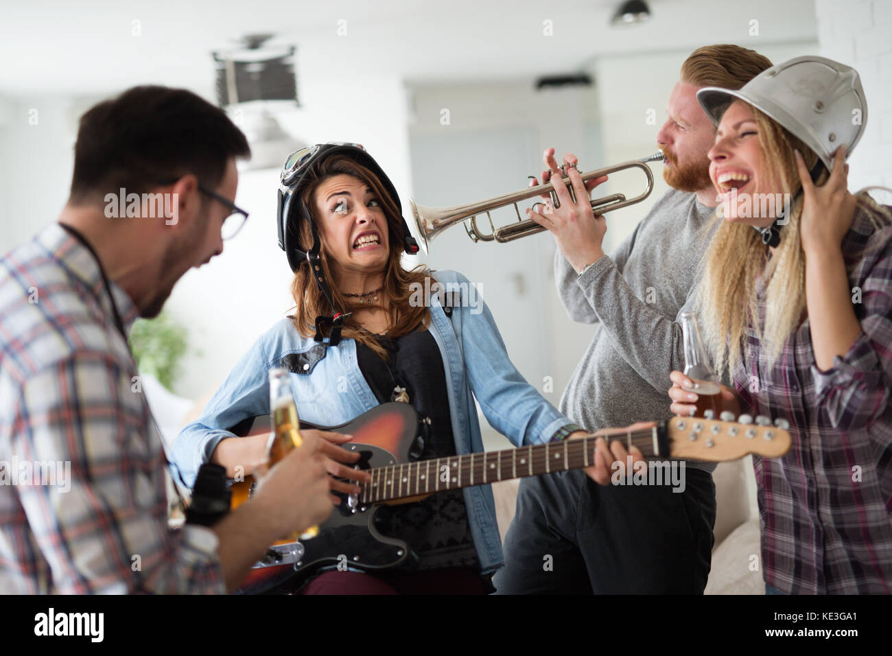 Friends having fun and partying in house and playing music Stock Photo ...