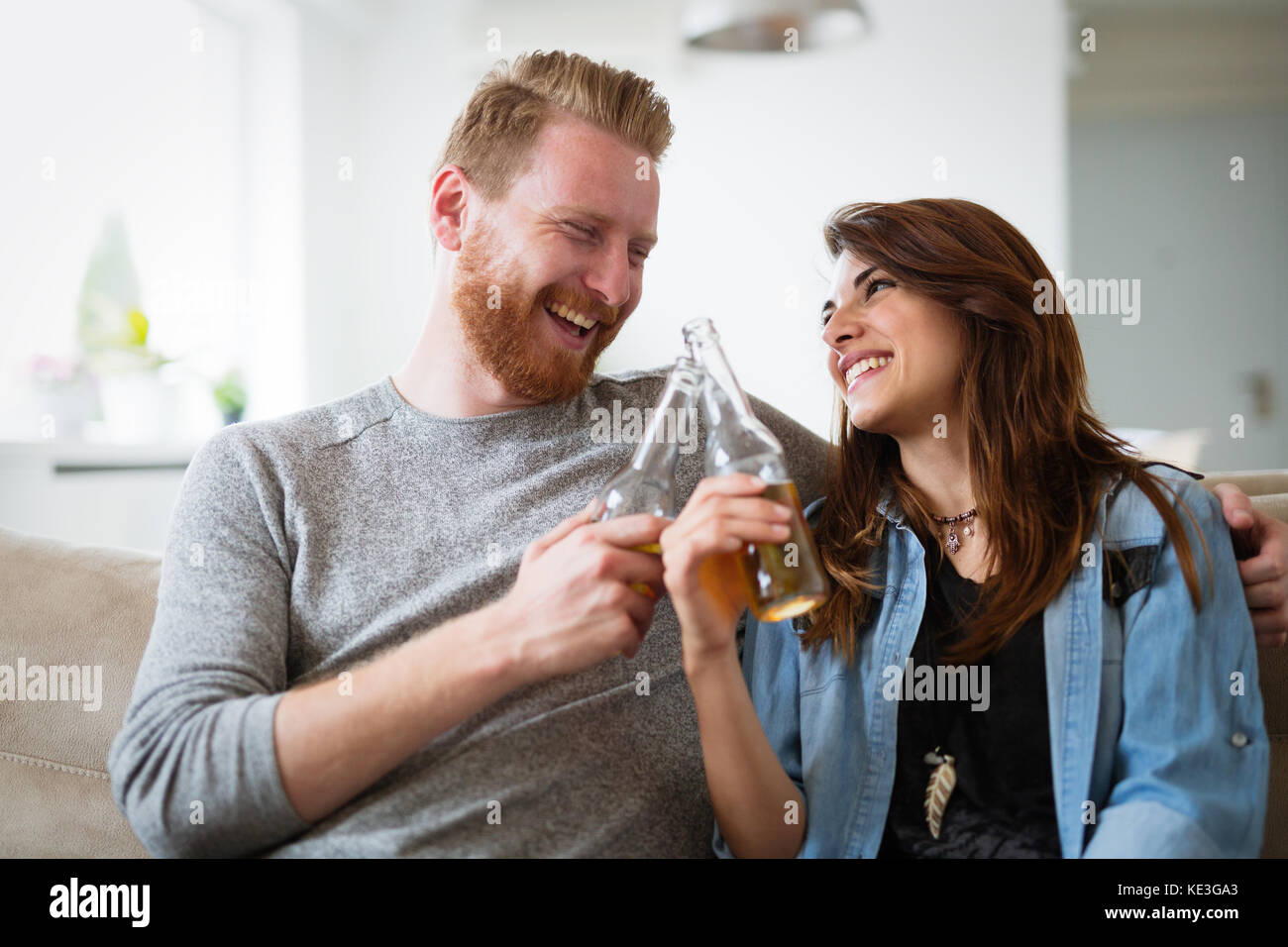 Young beautiful couple flirting and smiling at home Stock Photo - Alamy