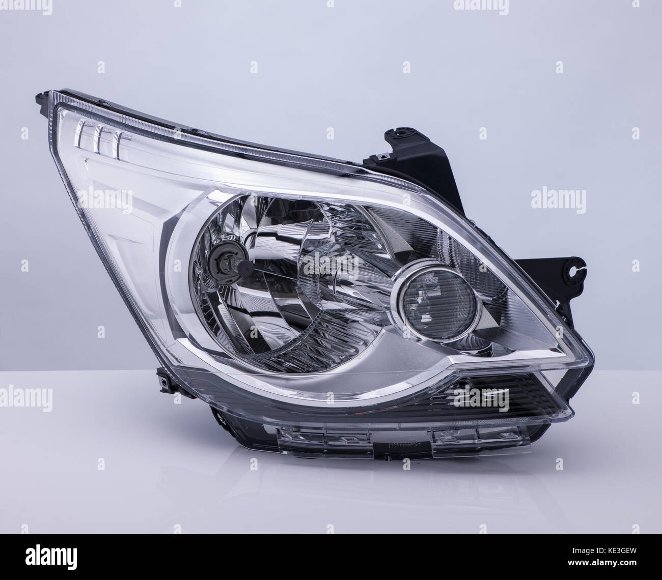 closeup of a car headlight on bright background with reflection ...