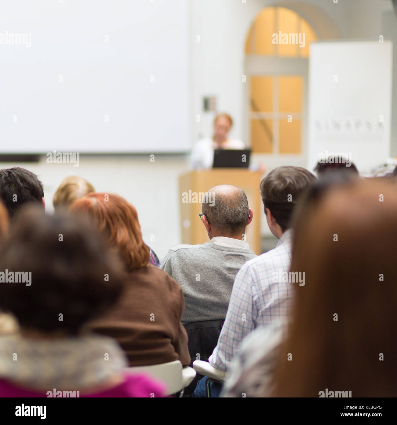 Woman giving presentation in lecture hall at university Stock Photo - Alamy