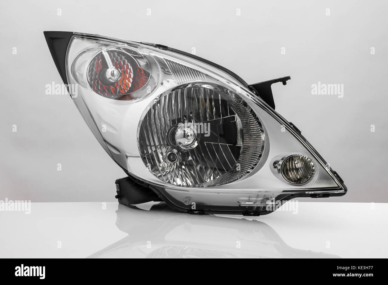 modern automotive headlight with reflection isolated on light ...
