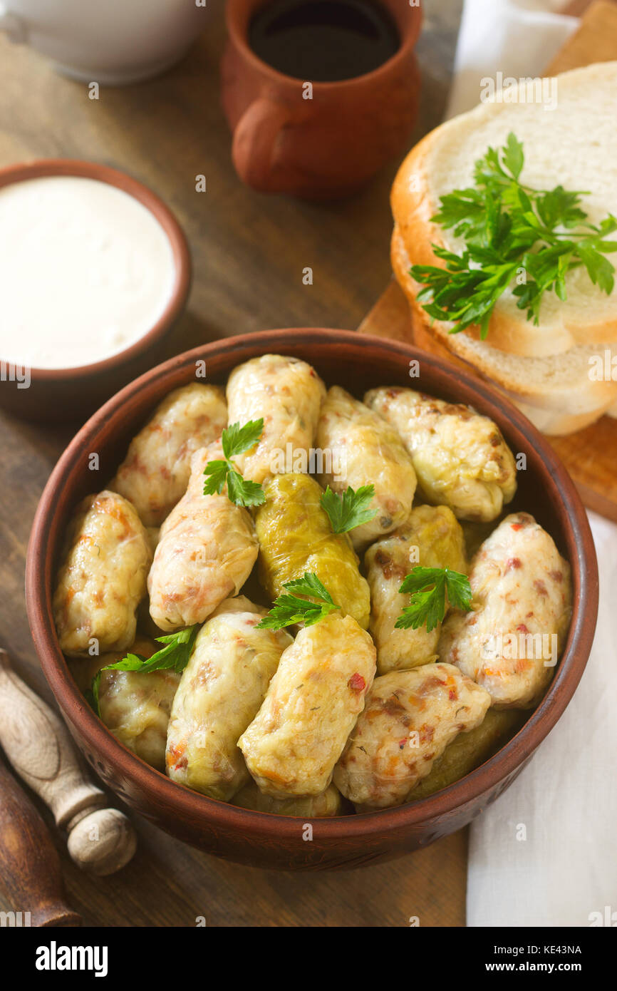 Cabbage rolls served with sour cream, bread and wine. Traditional ...