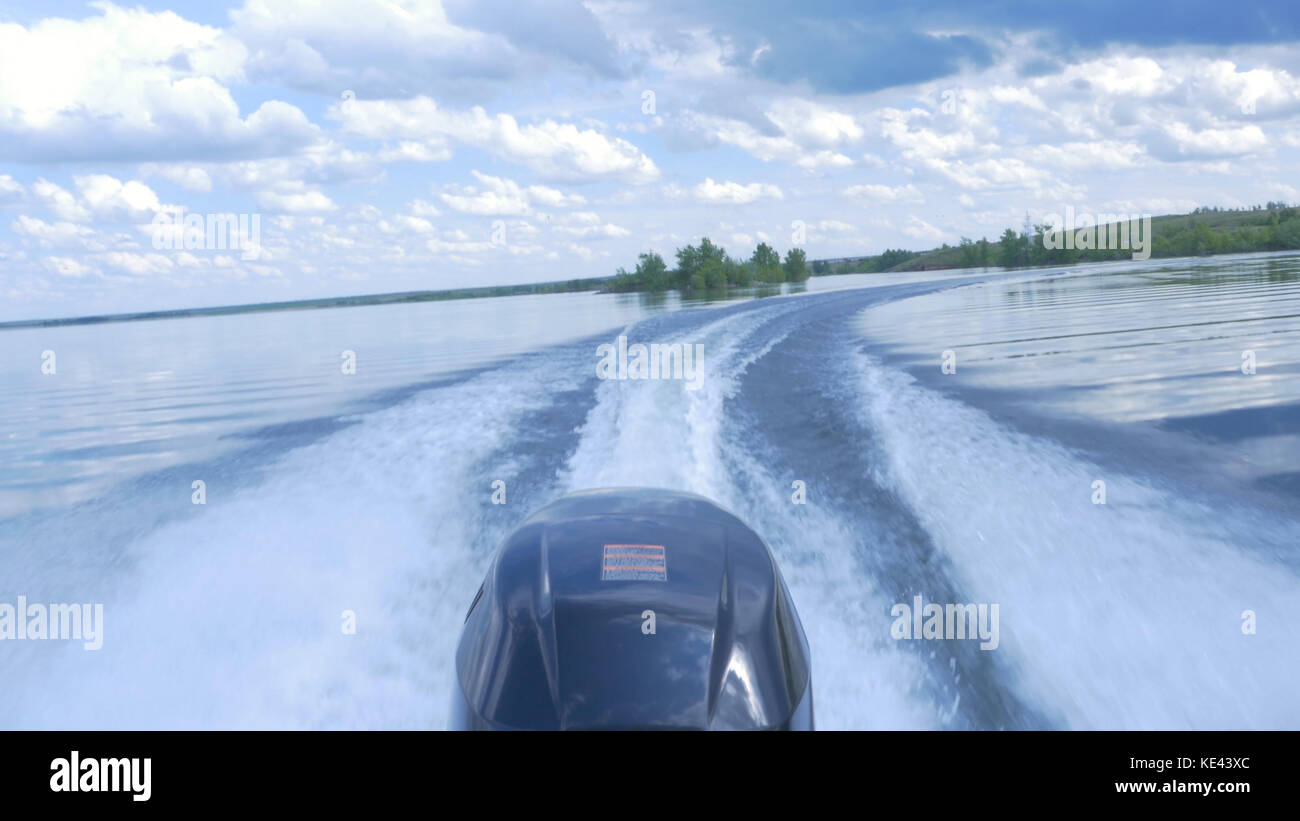 Trail on water surface behind of fast moving motor boat. the motor of ...
