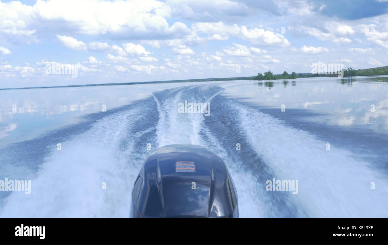 Trail on water surface behind of fast moving motor boat. the motor of ...