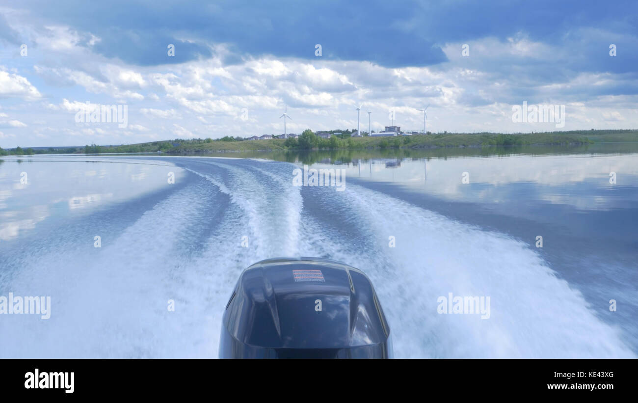 Trail on water surface behind of fast moving motor boat. the motor of ...