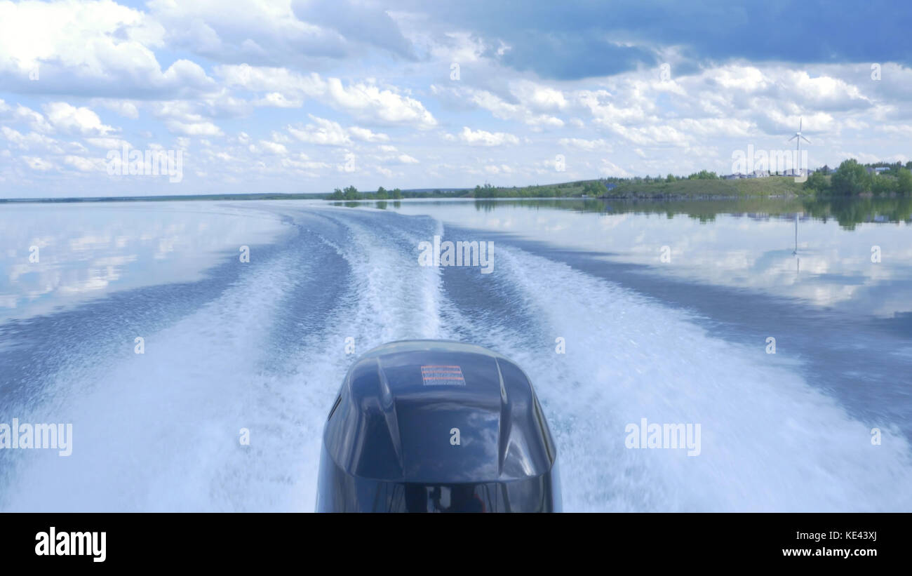 Trail on water surface behind of fast moving motor boat. the motor of ...