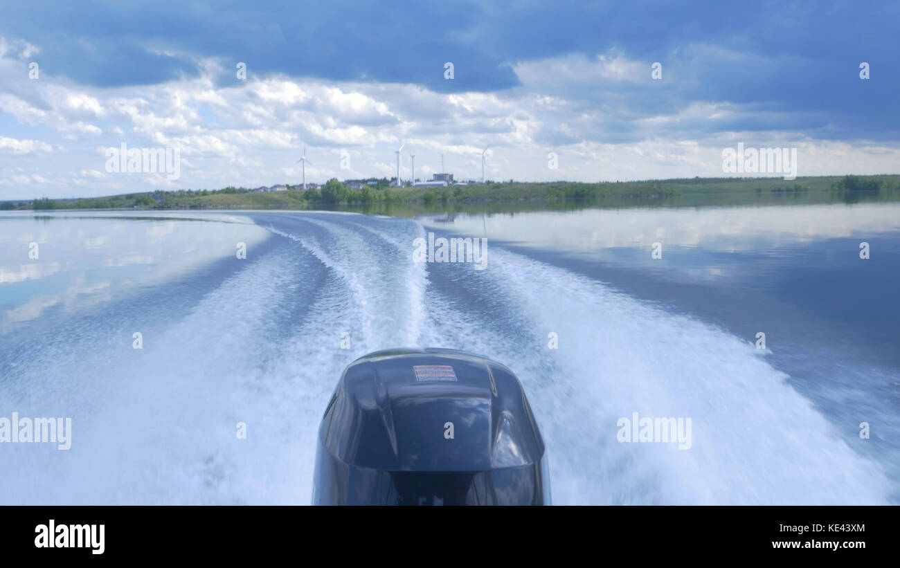 Trail on water surface behind of fast moving motor boat. the motor of ...