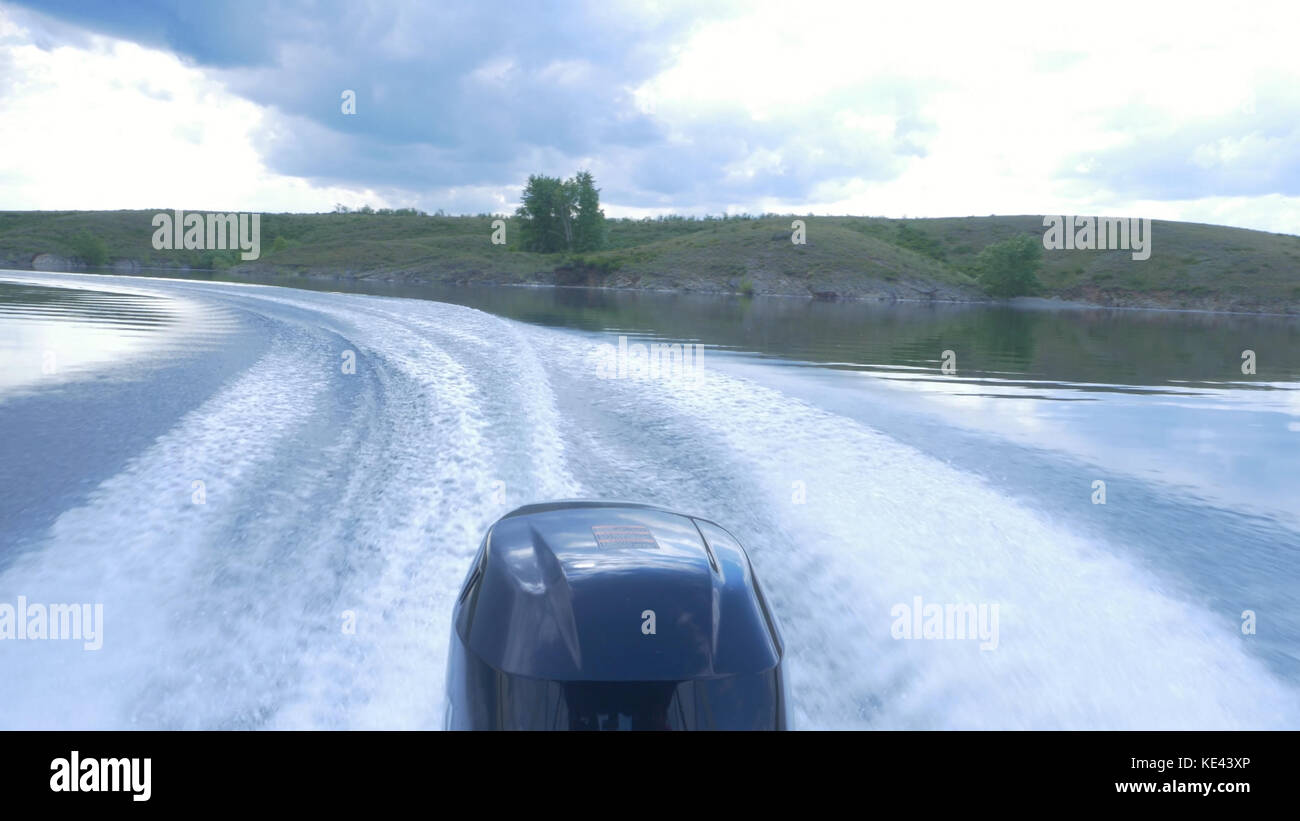 Trail on water surface behind of fast moving motor boat. the motor of ...