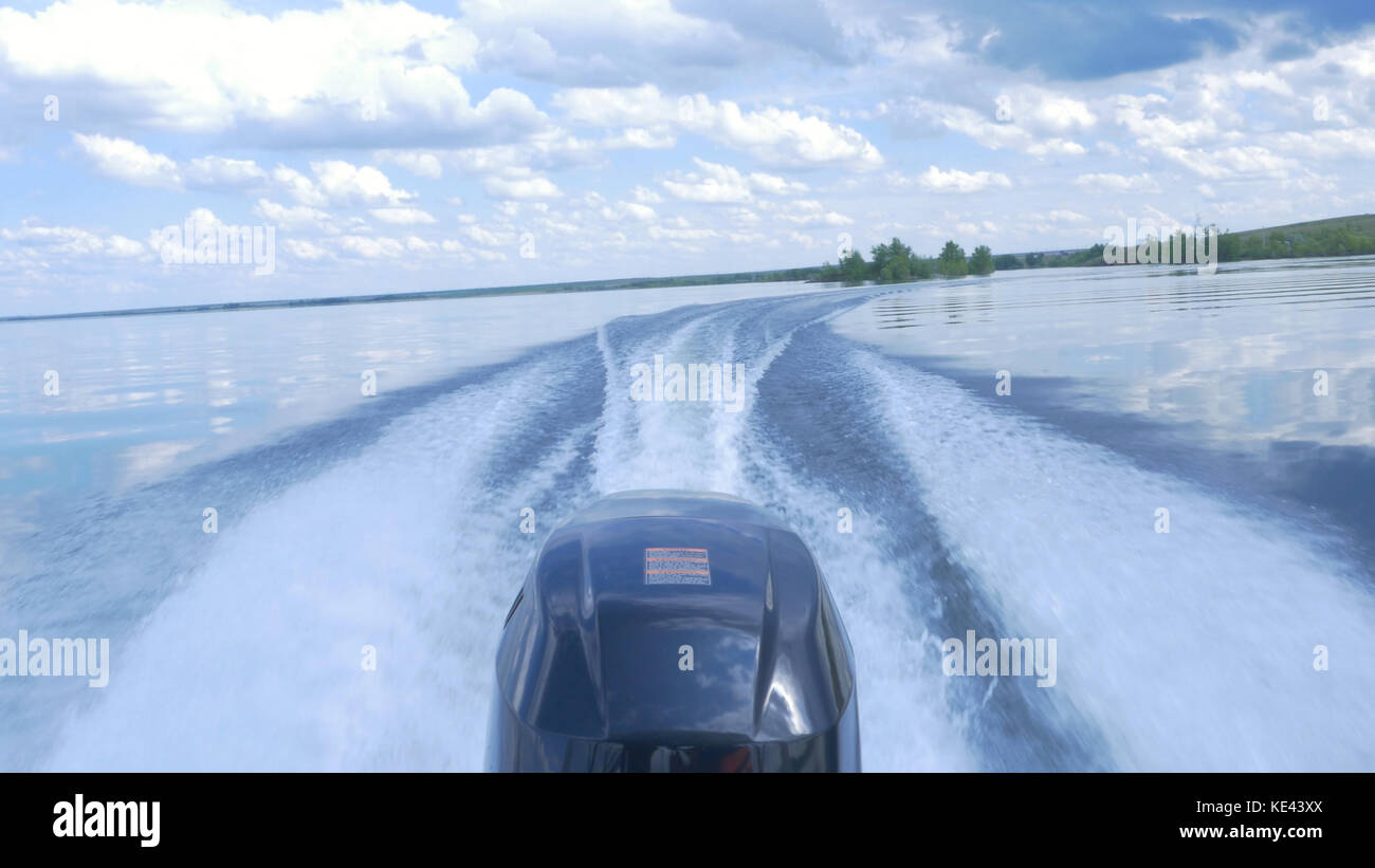 Trail on water surface behind of fast moving motor boat. the motor of ...