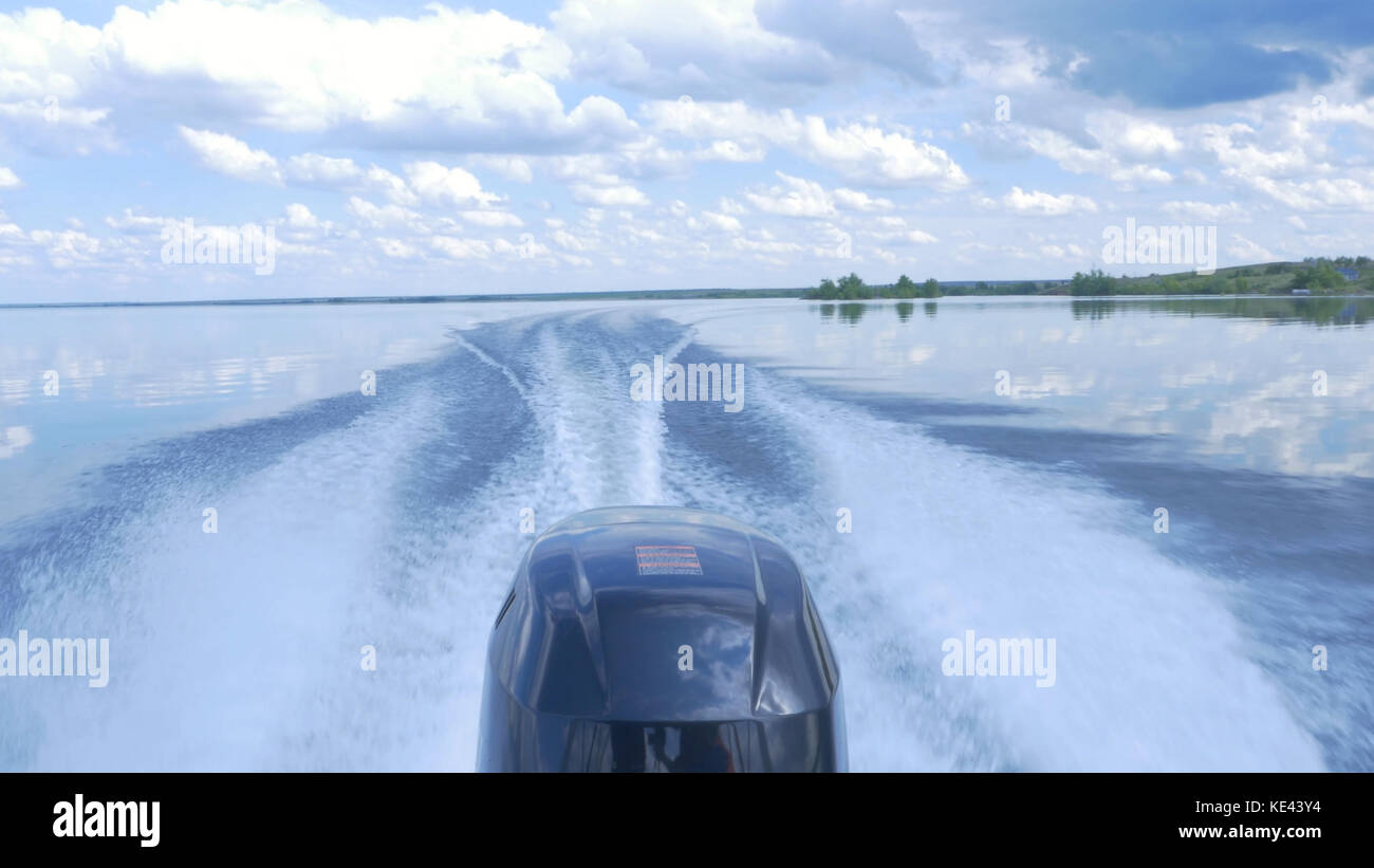 Trail on water surface behind of fast moving motor boat. the motor of ...