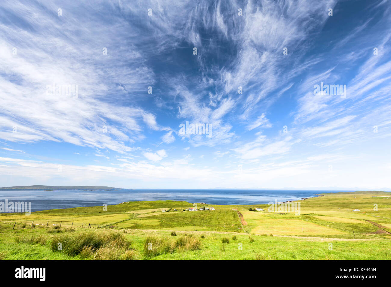 Blue sky over fields and ocean in Linicro on the Isle of Skye, Scotland ...