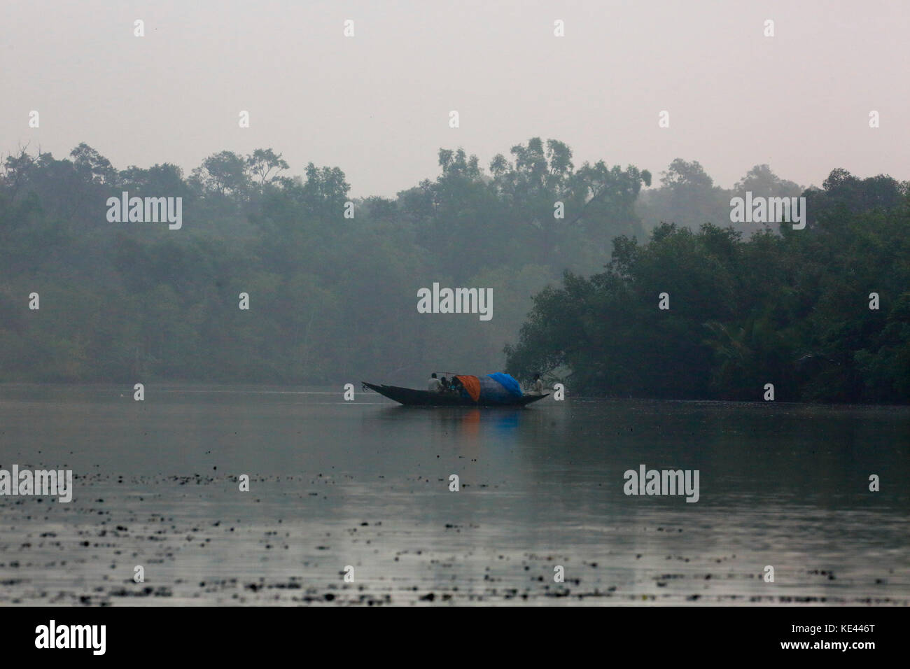 A fishing boat on the Shela River in Sundarbans, a UNESCO World ...