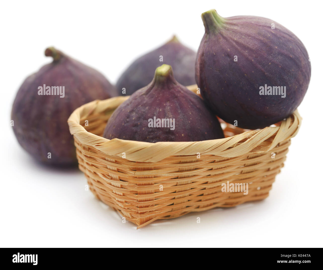 Fresh organic common fig in a basket over white background Stock Photo ...