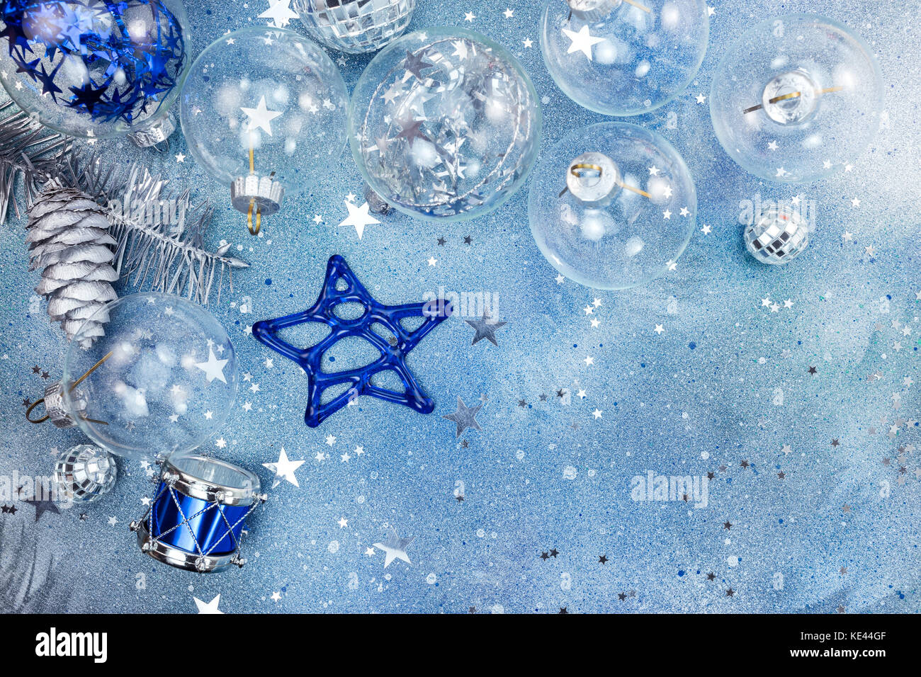 christmas balls with starry pattern, glass star and toy drum on silver ...