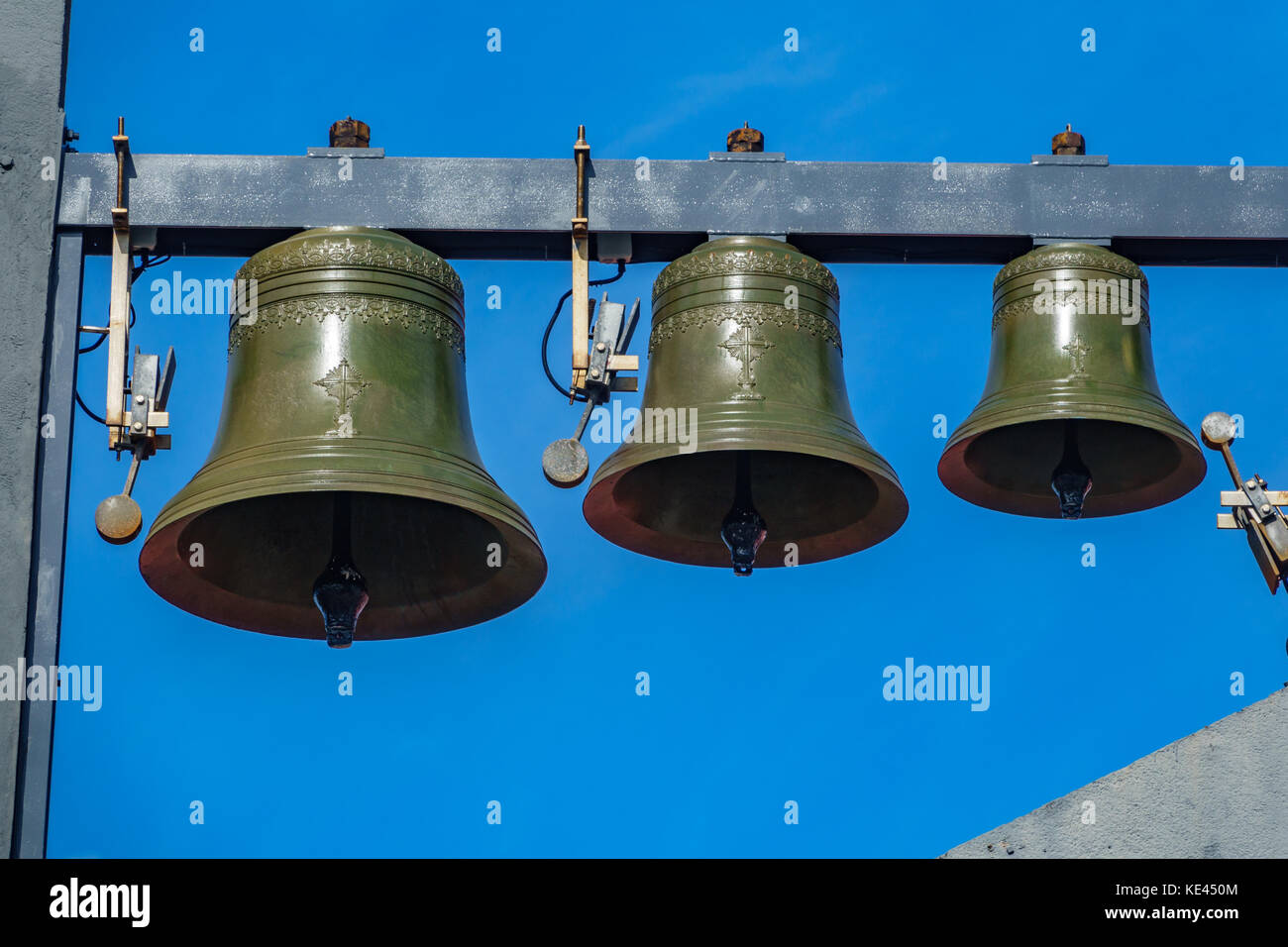 3 bells in a row with different size Stock Photo - Alamy