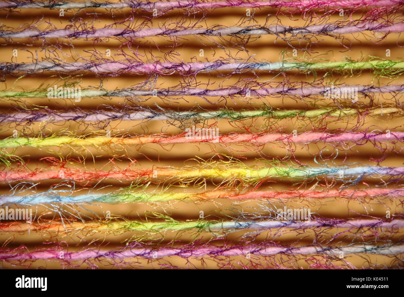 colorful yarns woven in loom frame by hand Stock Photo - Alamy